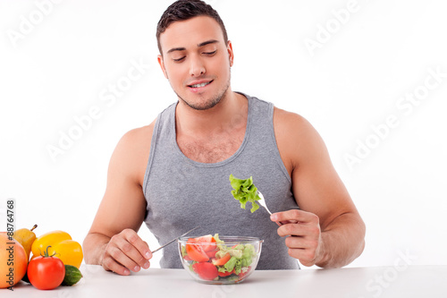 "Handsome young man is eating healthy food" Stock photo and royalty ...