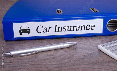 Car Insurance Binder On Desk In The Office With Pen And Calculator Car Insurance Binder On Desk In The Office With Pen And Calculator