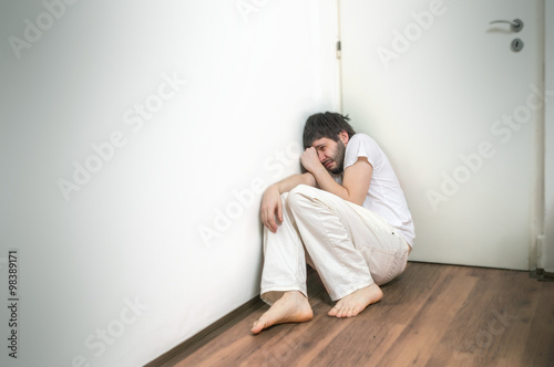 Lonely Sad Man Suffers From Depression And Crying On Floor Stock