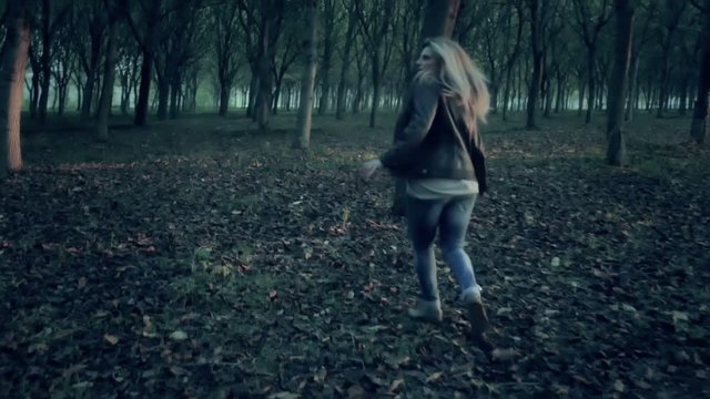 Scared Girl Running Away In The Woods