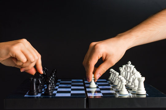 Hand Playing Chess