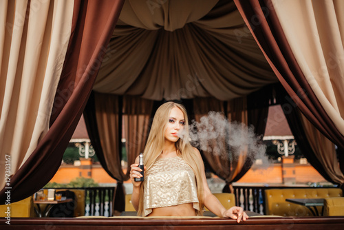 Vaping Young Beautiful Girl Smoking Vaping E Cigarette With Smoke