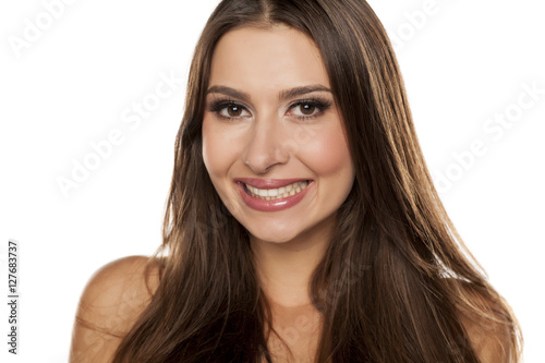 "portrait of a beautiful young woman with a fake smile on a white ...