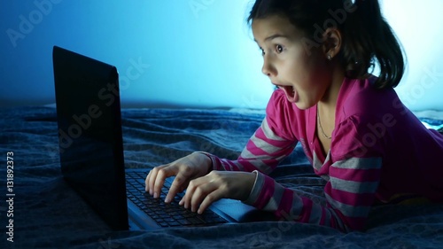 "Teen angry girl evil surprise working at laptop, the Internet play in ...