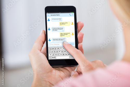 "Person Sending Text Message Using Mobile Phone" photo libre de droits ...