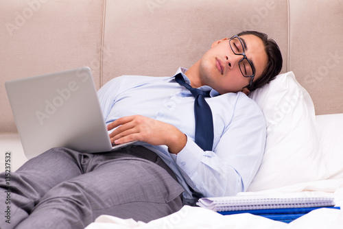"Businessman working in the bed at home" photo libre de droits sur la ...