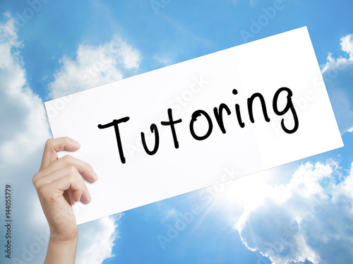 "Tutoring Sign on white paper. Man Hand Holding Paper with text ...