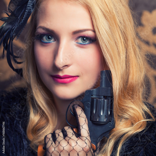 "beautiful retro woman holding a revolver" Stock photo and royalty-free ...