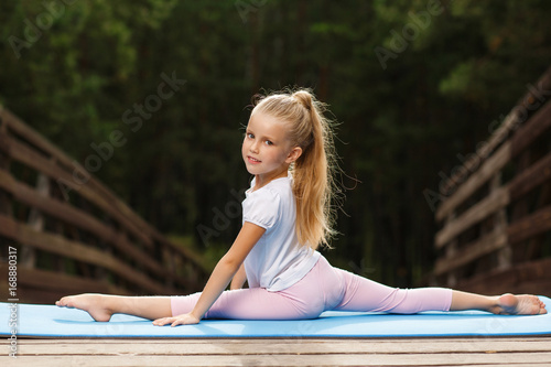 "Little girl sitting on the splits, outdoor" Stock photo and royalty ...