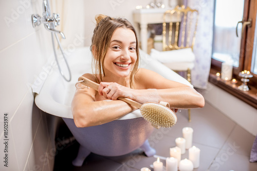 Portrait Of A Beautiful Woman Lying With Brush In The Retro Bath In