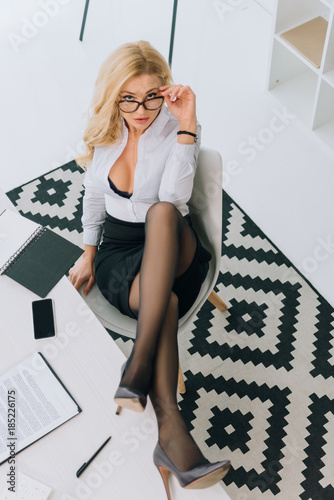 Overhead View Of Sexy Woman Sitting In Chair And Looking At Camera