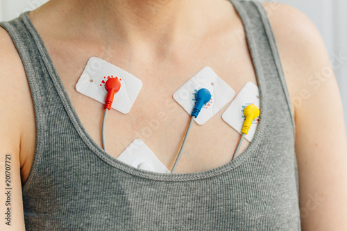 "Woman wearing holter monitor device for daily monitoring of an ...