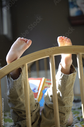 "Closeup little boy's feet on bed while he is reading" Stock photo and ...