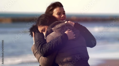 Two Sad Women Hugging Crying In Front Of The Ocean Slow Motion Closeup