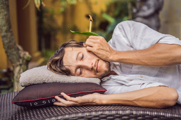 Woman Receiving Ear Candling Therapy at a Relaxing Spa from Pikwizard