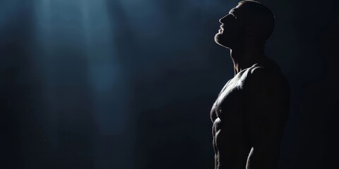 A photograph of a muscular strong man standing at a dark place and ...