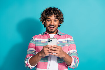 Photo of cheerful glad man wear stylish striped clothes read facebook ...